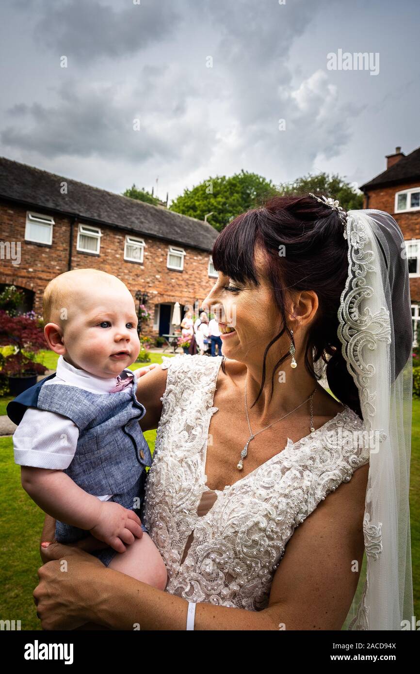 A bride, mother poses with her baby boy after getting married in the ...
