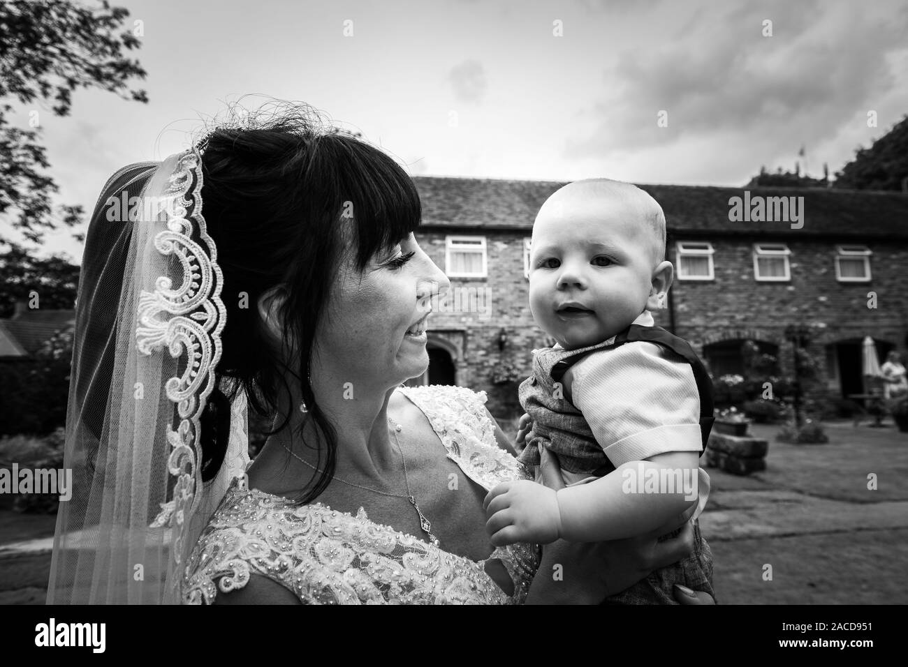 A bride, mother poses with her baby boy after getting married in the ...