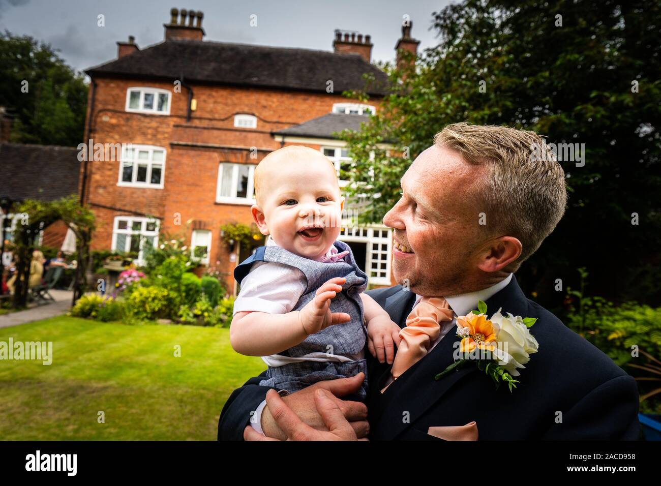 A groom, father poses with his baby boy after getting married in the ...