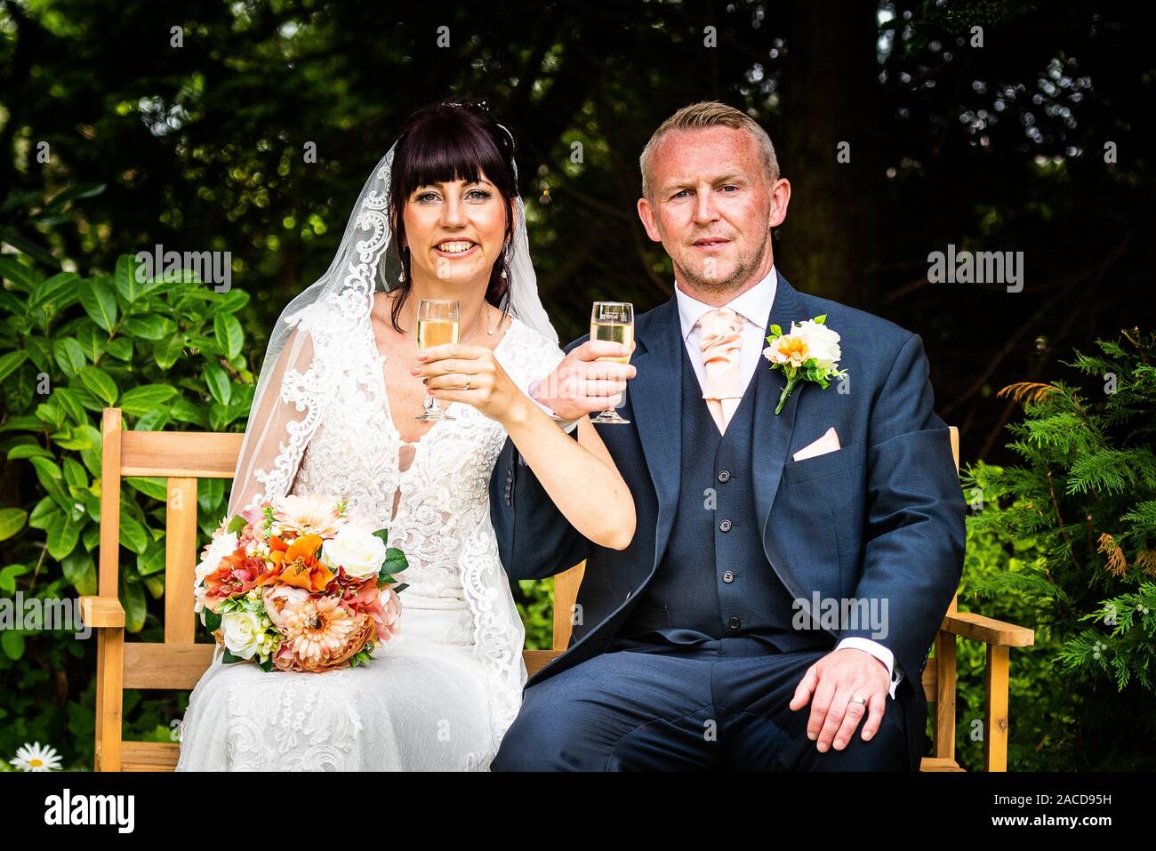 Bride and Groom pose for their after ceremony pictures in the gardens ...