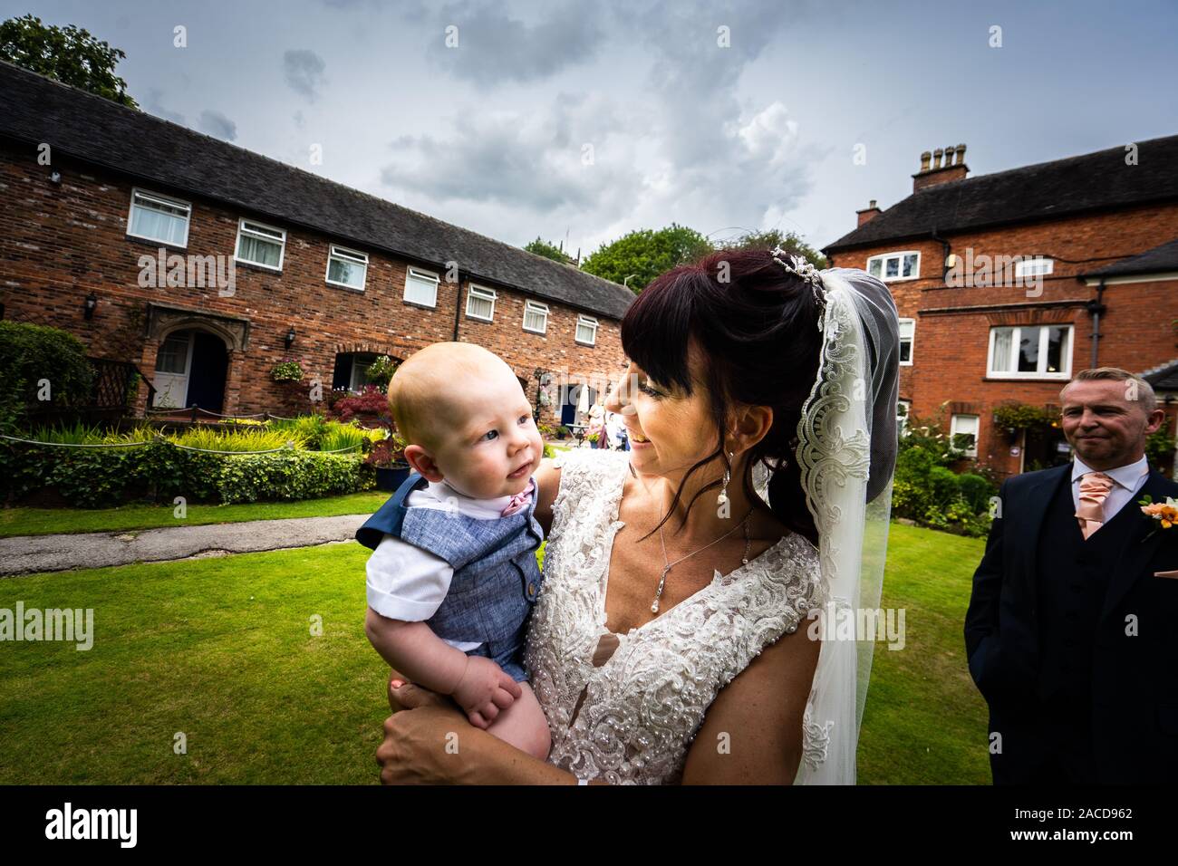 A bride, mother poses with her baby boy after getting married in the ...