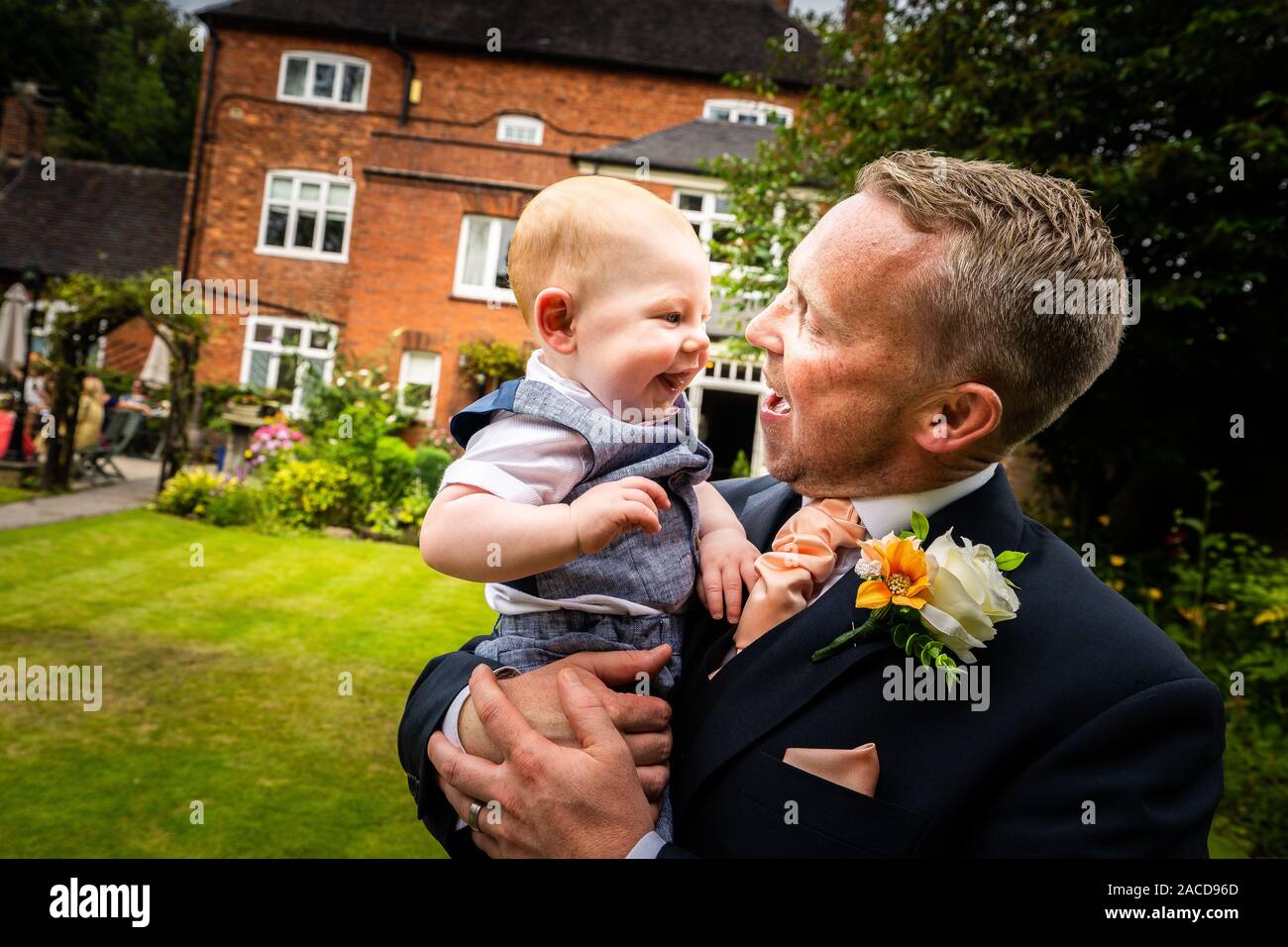 A groom, father poses with his baby boy after getting married in the ...