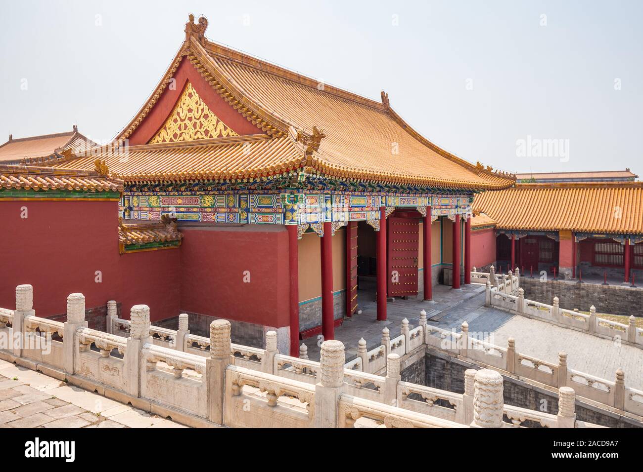 Traditional Chinese house with red doors with decorations and columns ...