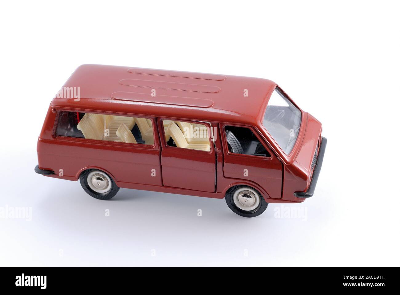 Reduced copy of a red passenger retro minibus car on a white background ...