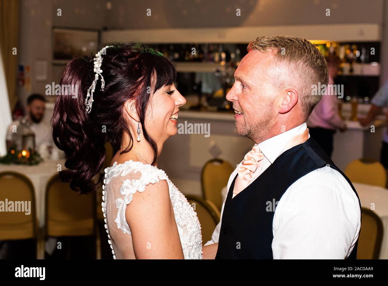 A bride and groom smiling, laughing together happy and in love on their ...