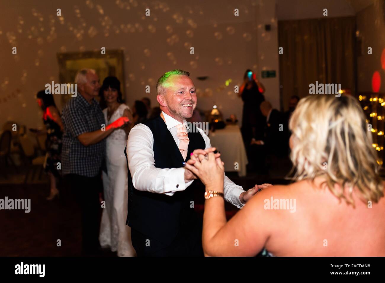 People dance and enjoy themselves at a wedding reception, after party ...