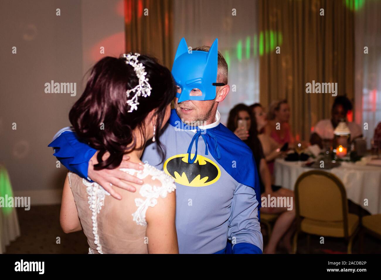 A groom dressed as Batman having fun with his new wife during their ...