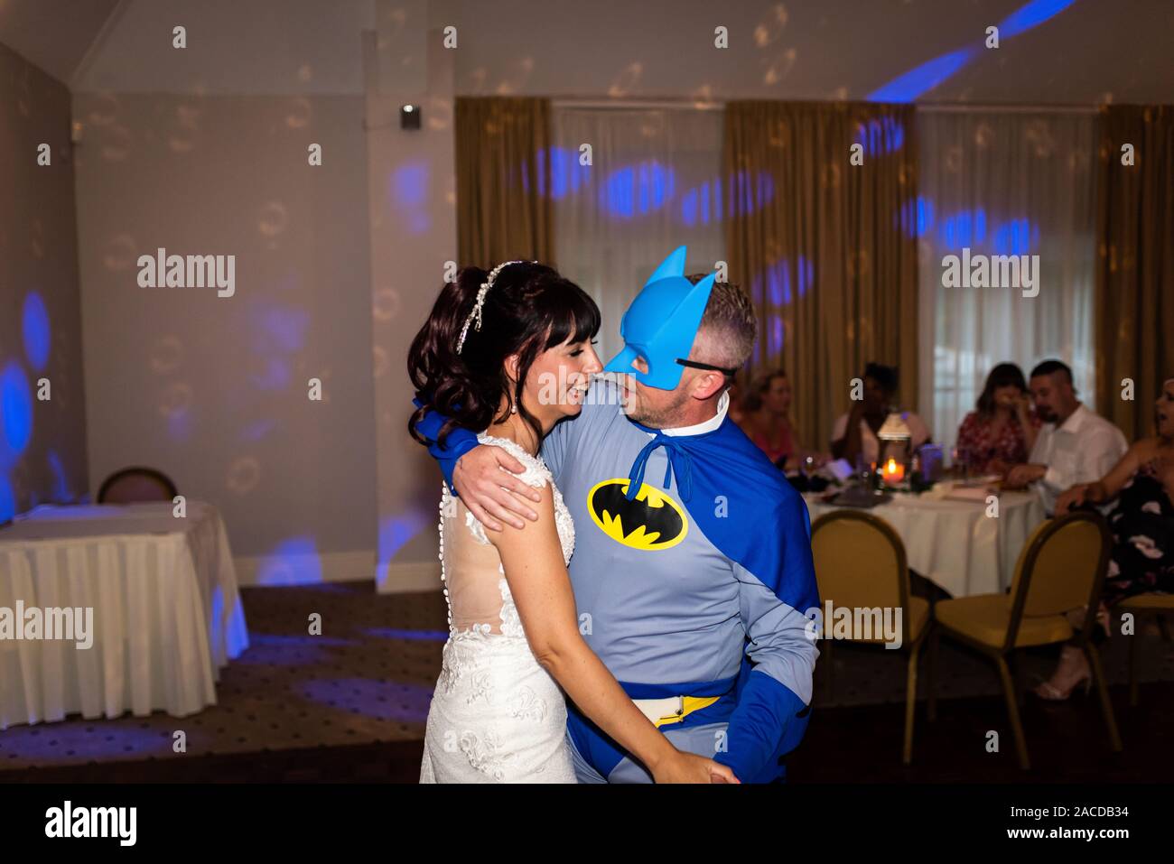 A groom dressed as Batman having fun with his new wife during their ...