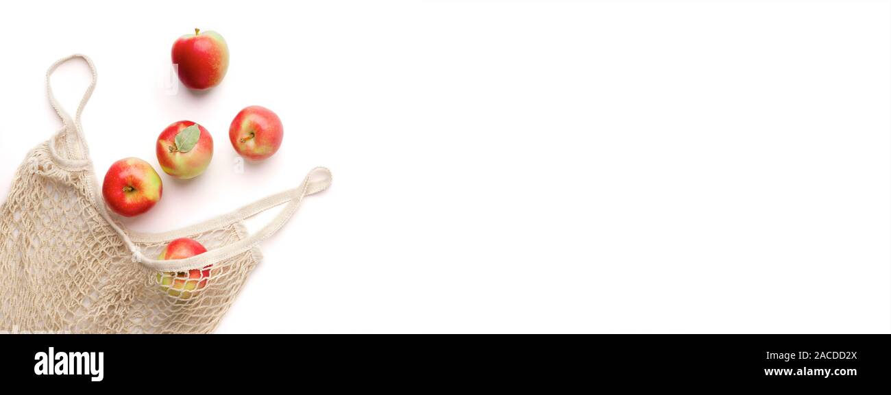 Red apples in reusable net bag on white background Stock Photo - Alamy