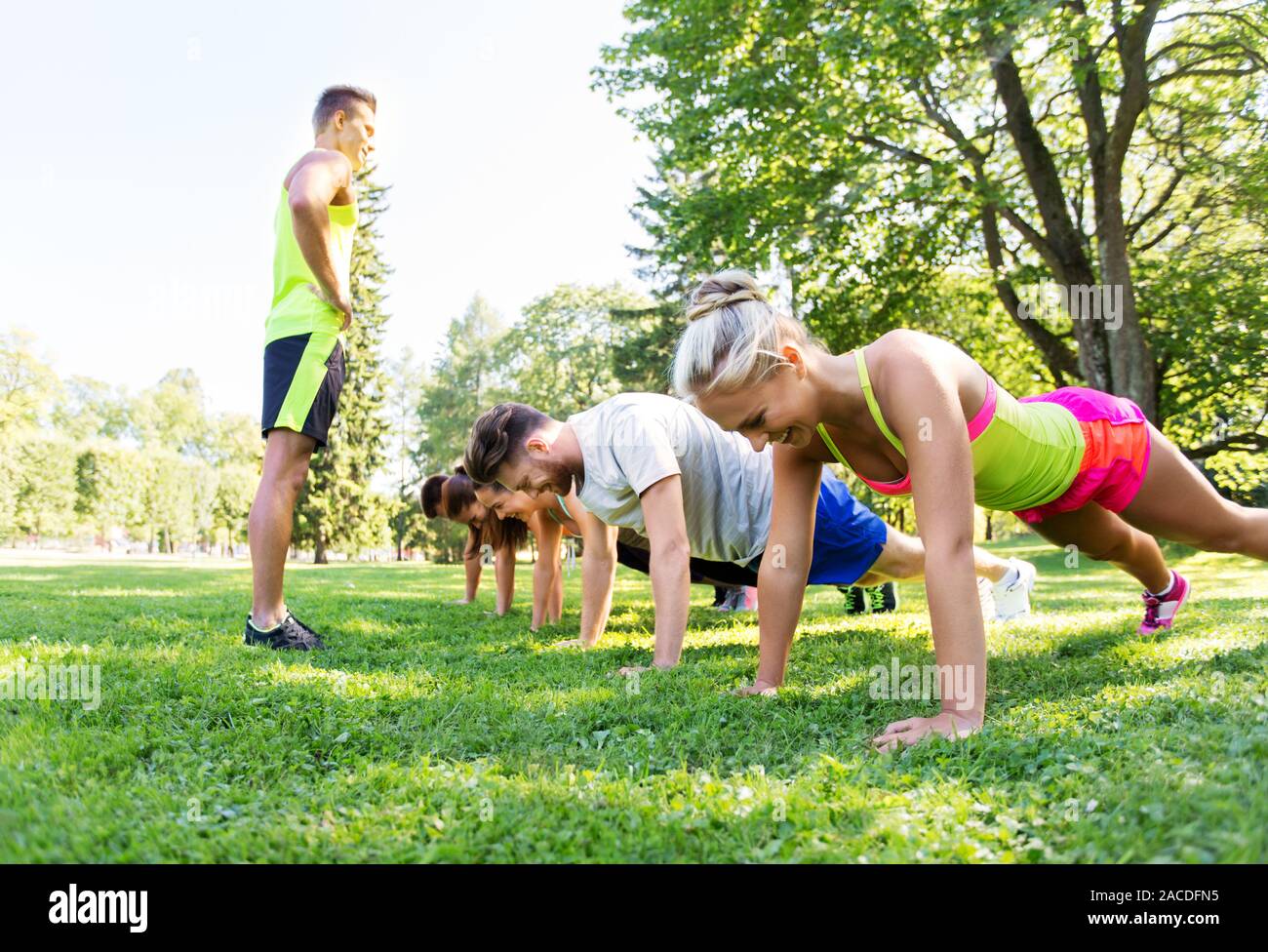 group of people exercising at park in summer Stock Photo - Alamy