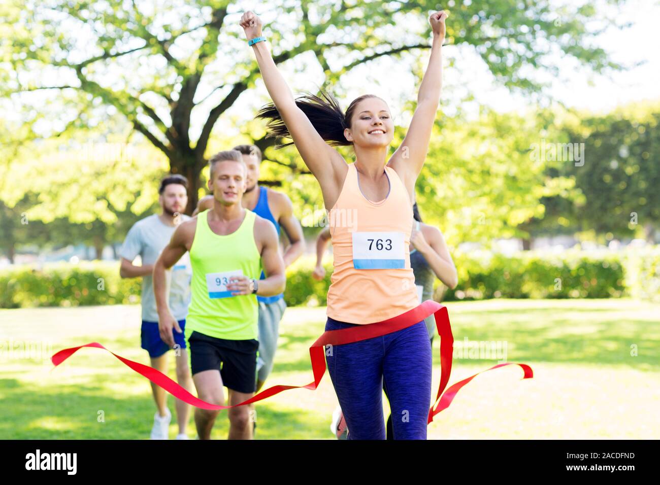 Female athlete crossing finish line hi-res stock photography and images ...