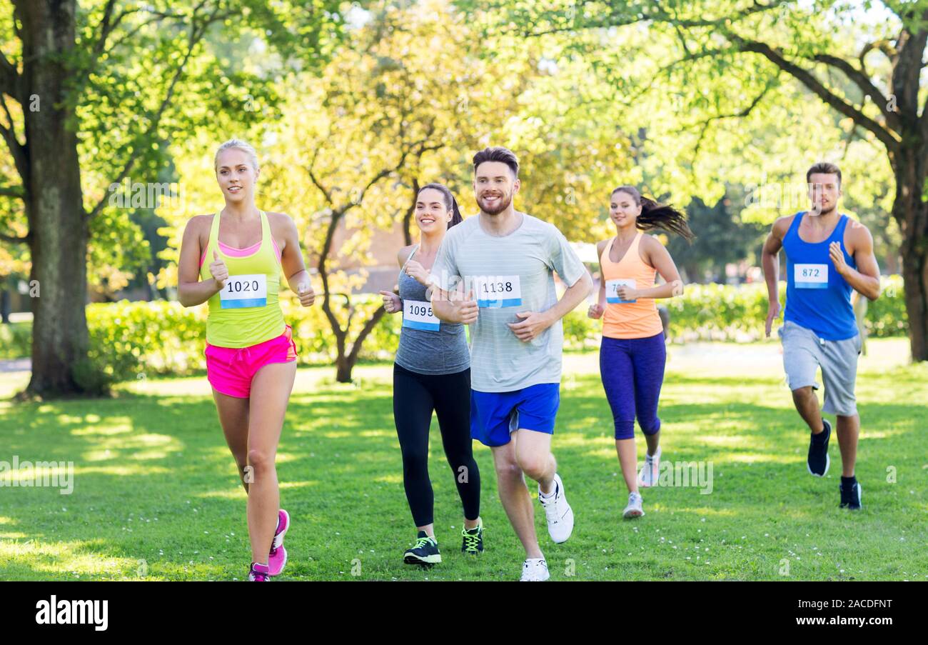 happy young sportsmen racing wit badge numbers Stock Photo - Alamy