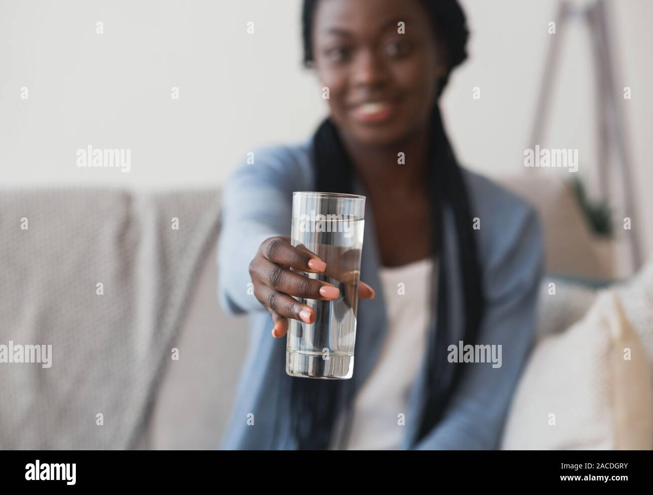 Young woman offering glass water hi-res stock photography and images ...