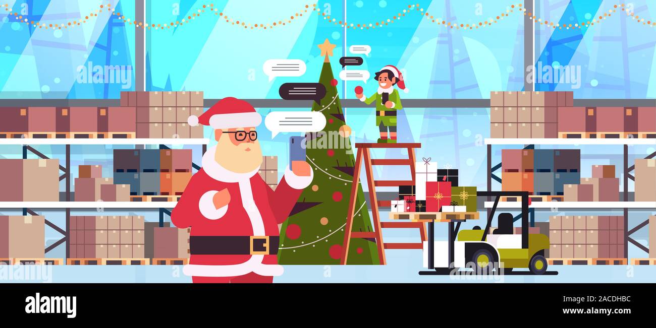 santa with male elf helper chatting using mobile app on smartphone ...