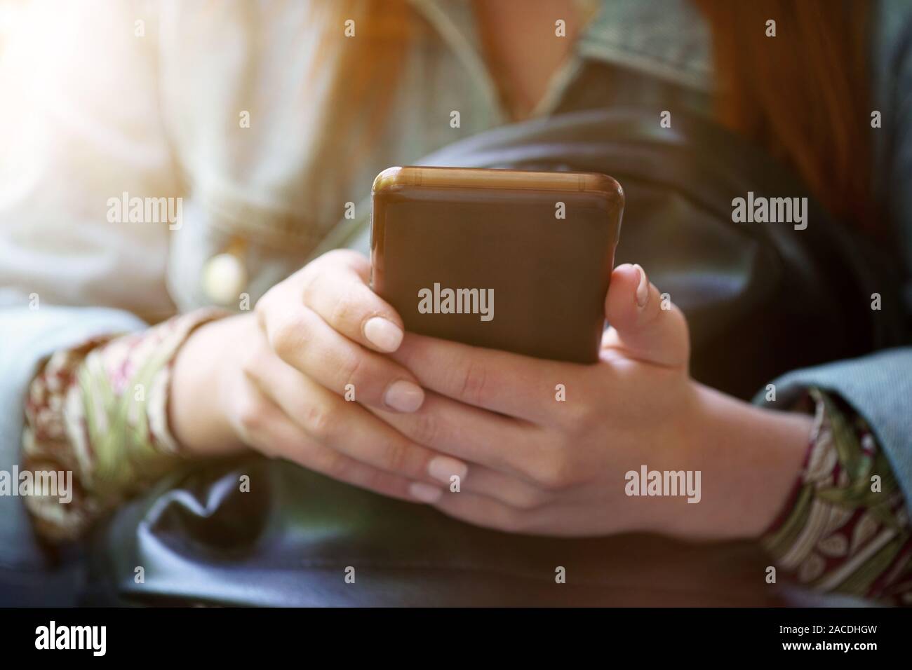 midsection of unrecognizable young woman using her smartphone or mobile ...