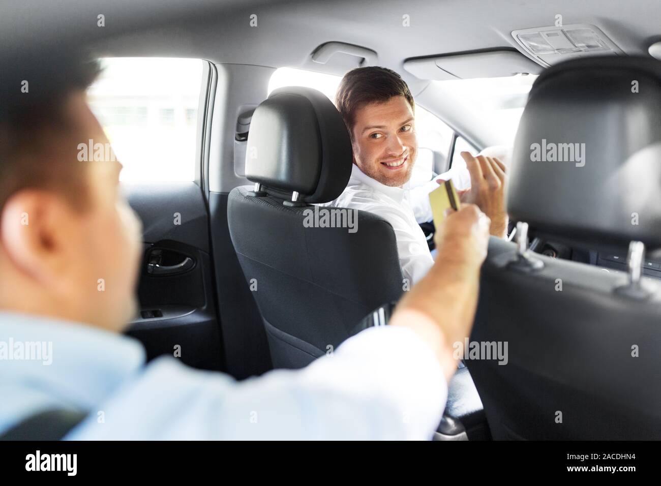 male car driver taking credit card from passenger Stock Photo - Alamy