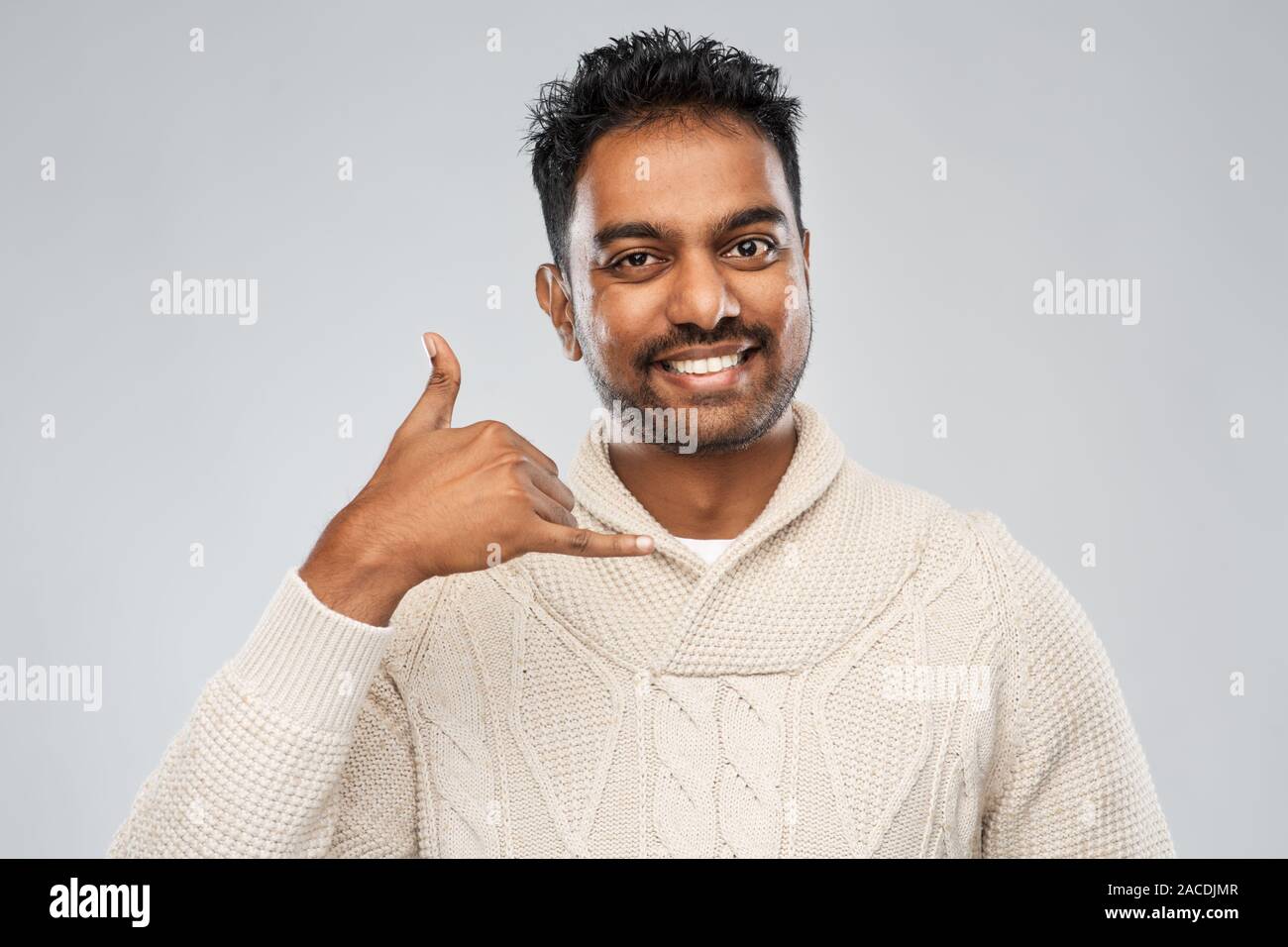 Happy indian man in jumper hi-res stock photography and images - Alamy