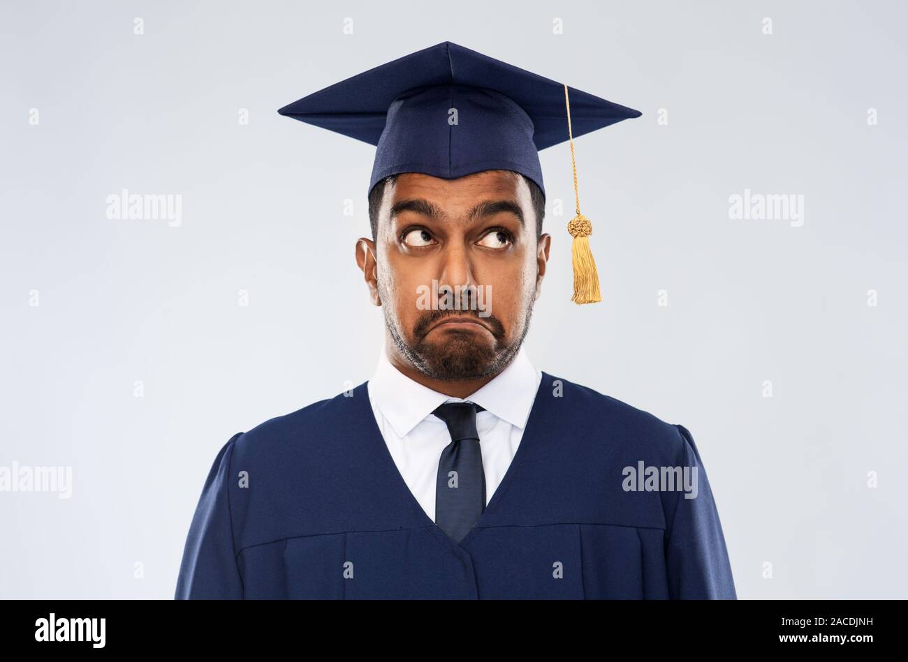 confused indian graduate student in mortar board Stock Photo - Alamy