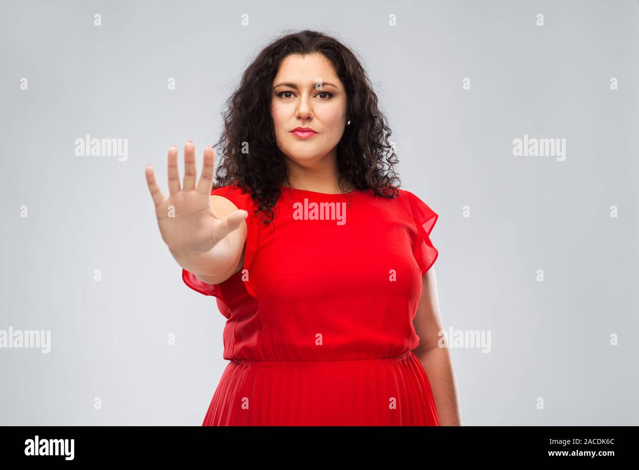 woman in red dress showing stop gesture Stock Photo - Alamy