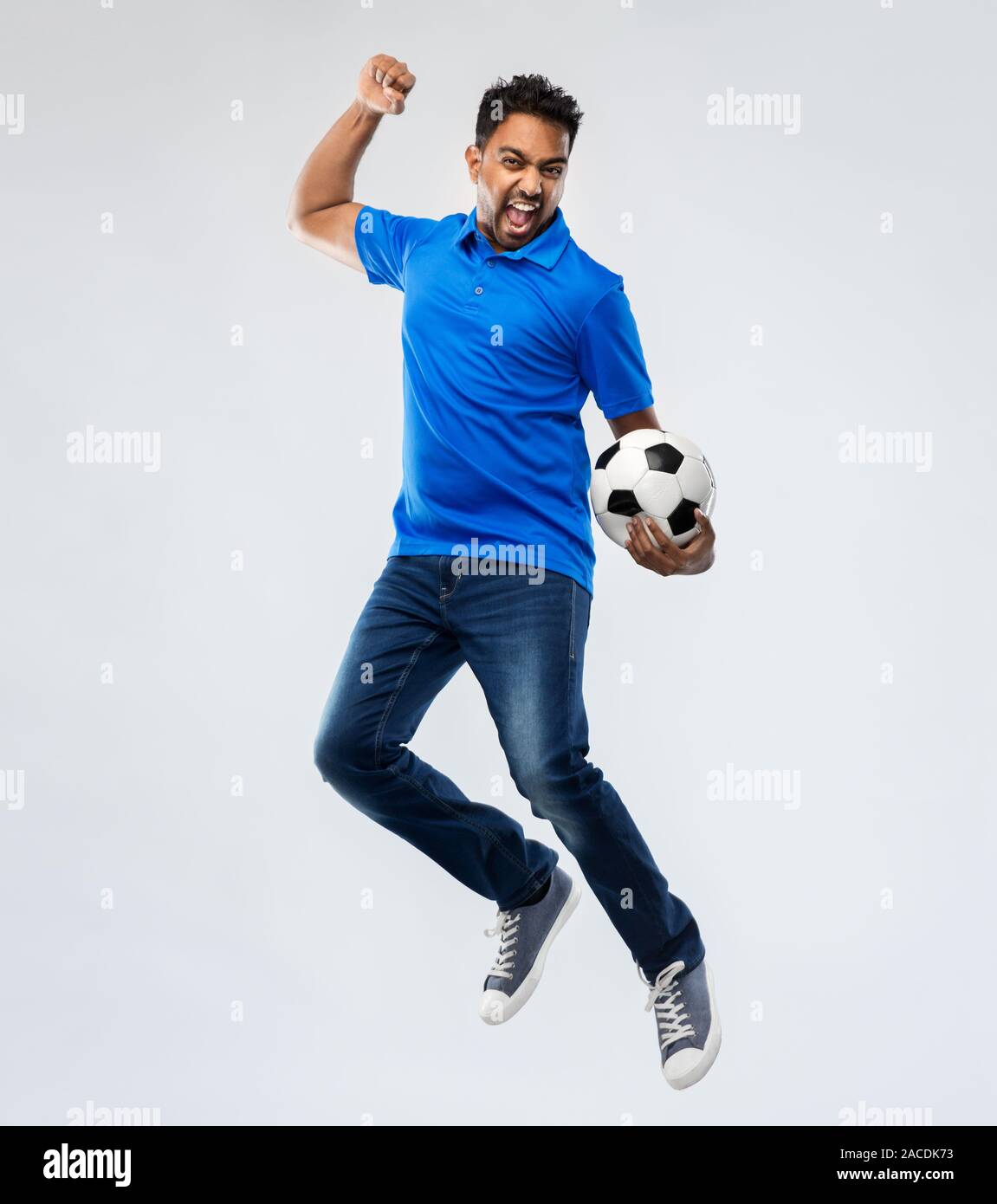 man or football fan with soccer ball jumping Stock Photo - Alamy