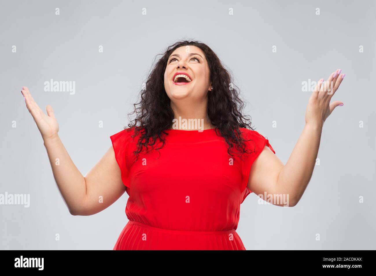 Excited woman in red dress hi-res stock photography and images - Alamy