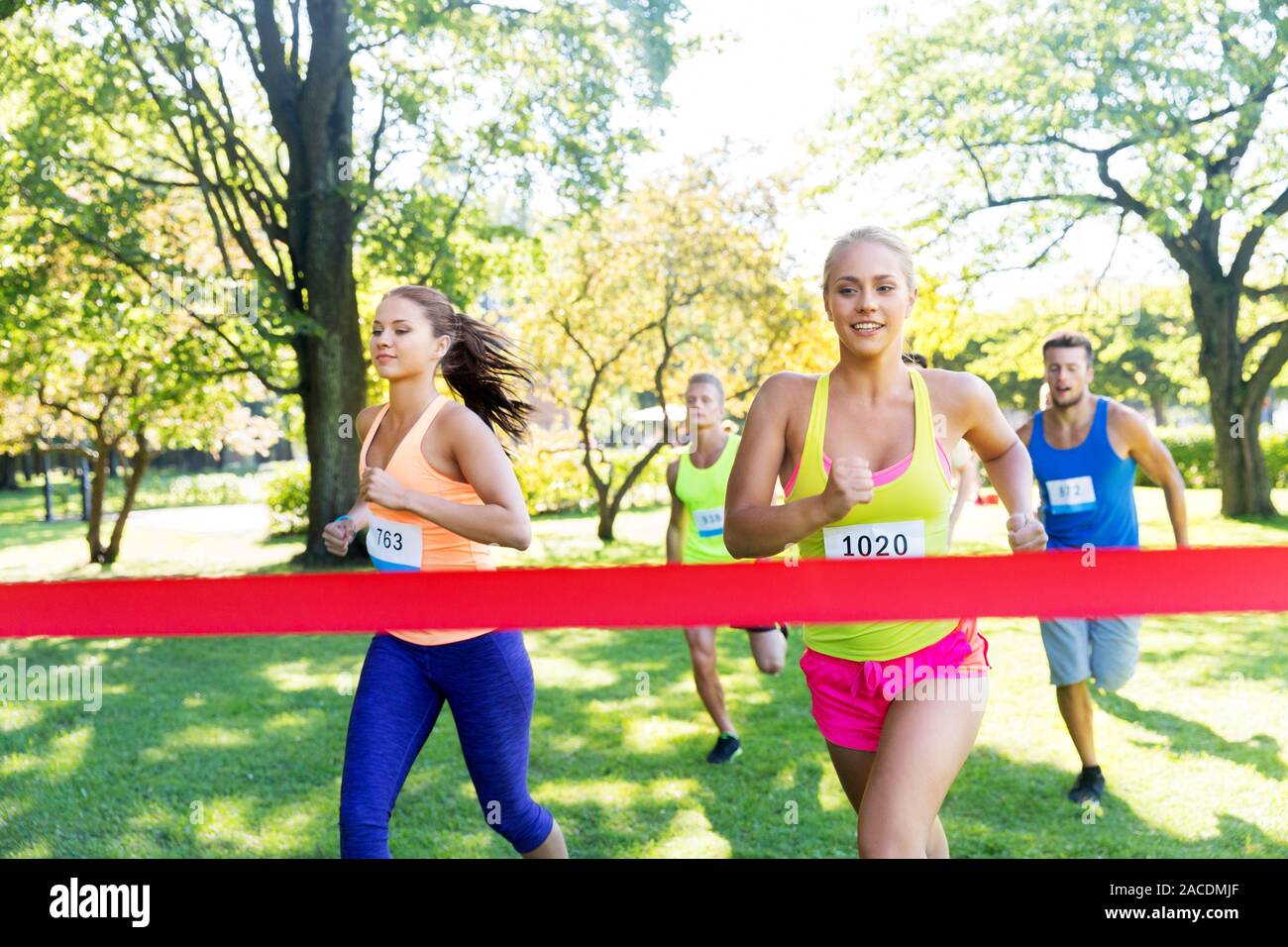 Female athlete crossing finish line hi-res stock photography and images - Alamy