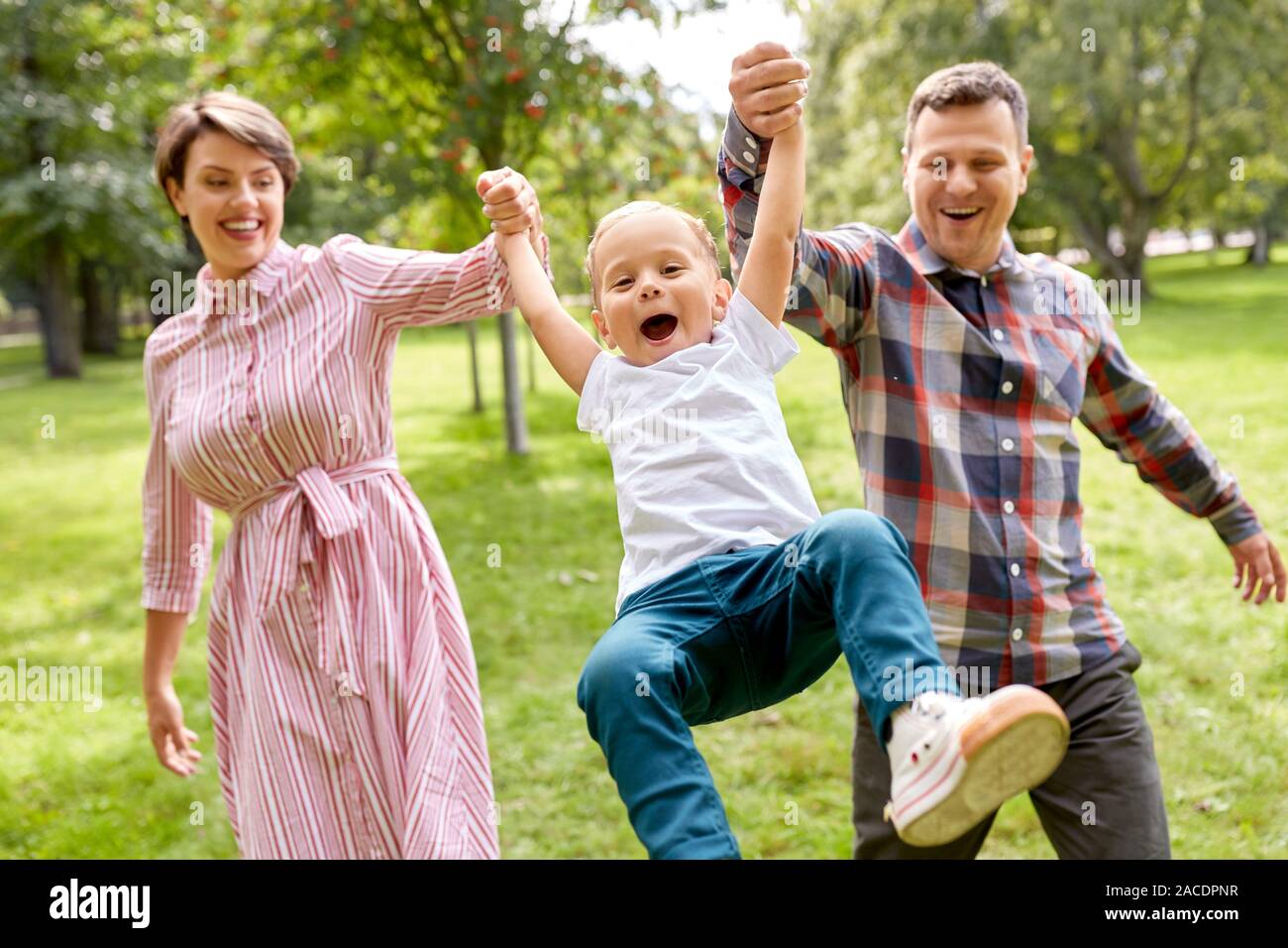 happy family having fun at summer park Stock Photo - Alamy
