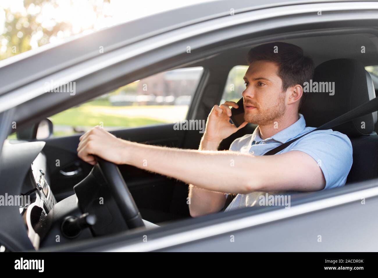 man driving car and calling on smartphone Stock Photo - Alamy