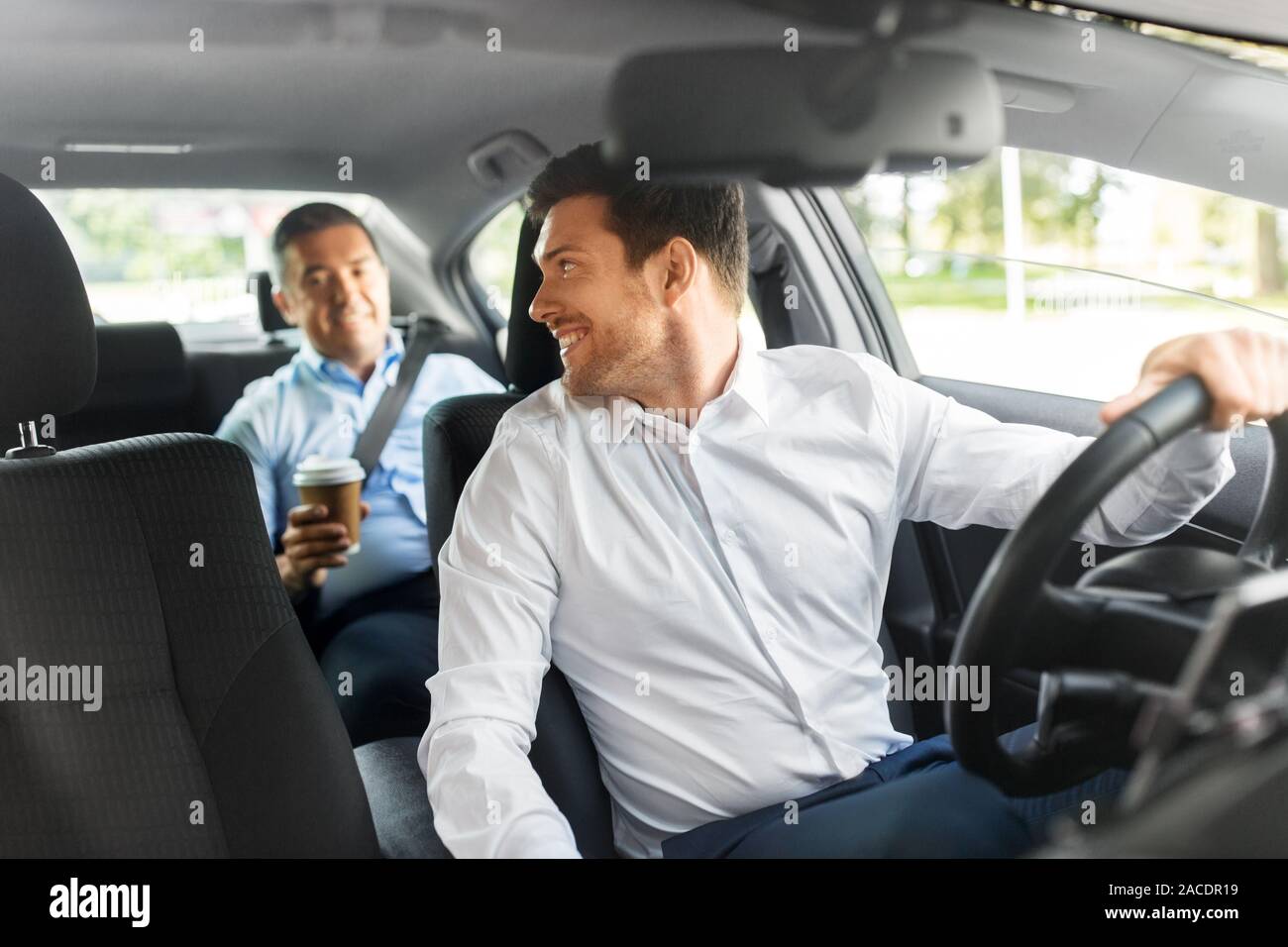 male car driver talking to passenger with coffee Stock Photo - Alamy