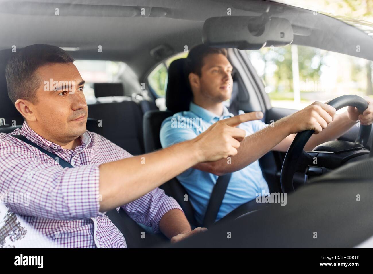 car driving school instructor teaching male driver Stock Photo - Alamy