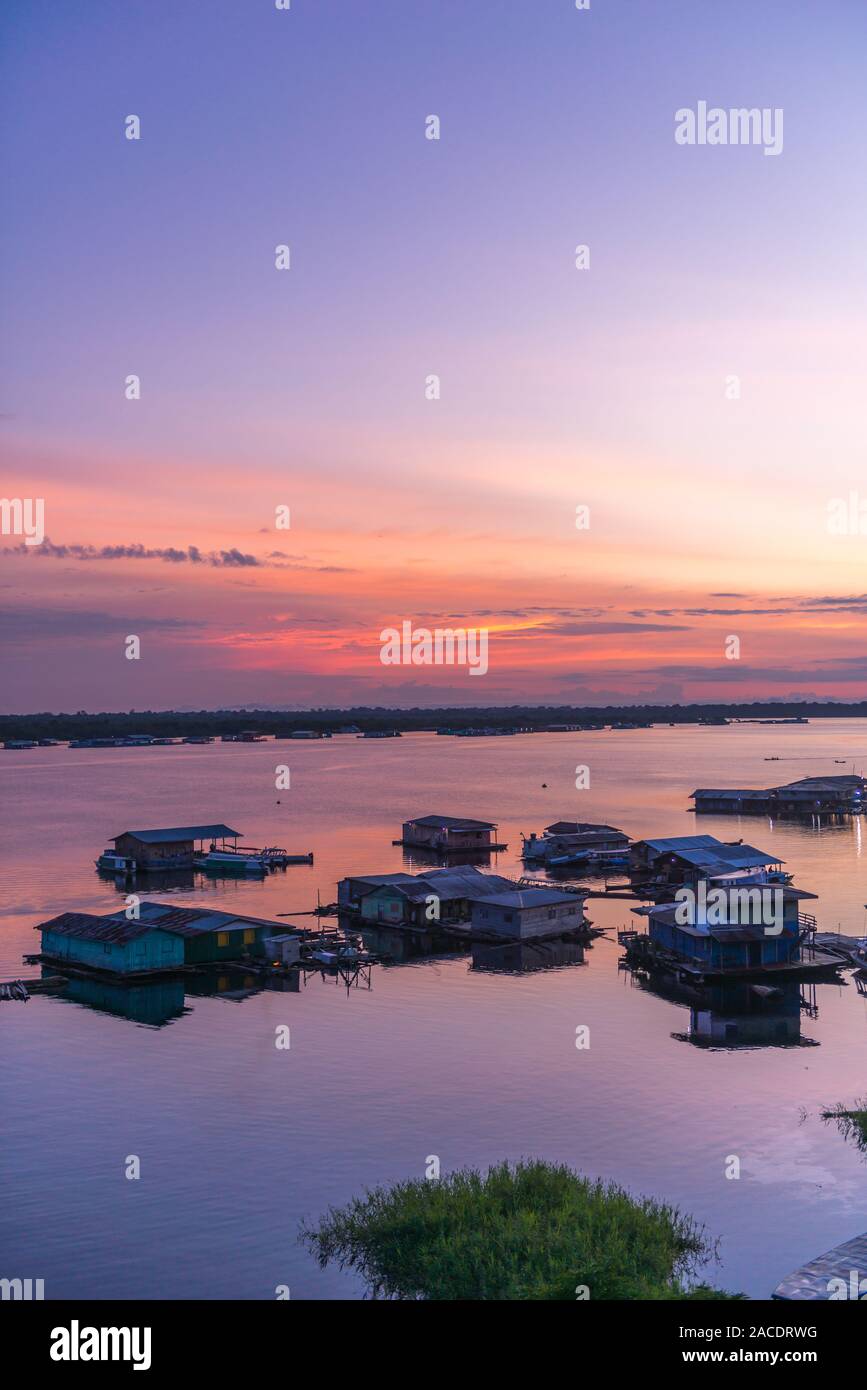 Twilight hour over the swimming houses on Lake Tefé, small town of Tefé ...