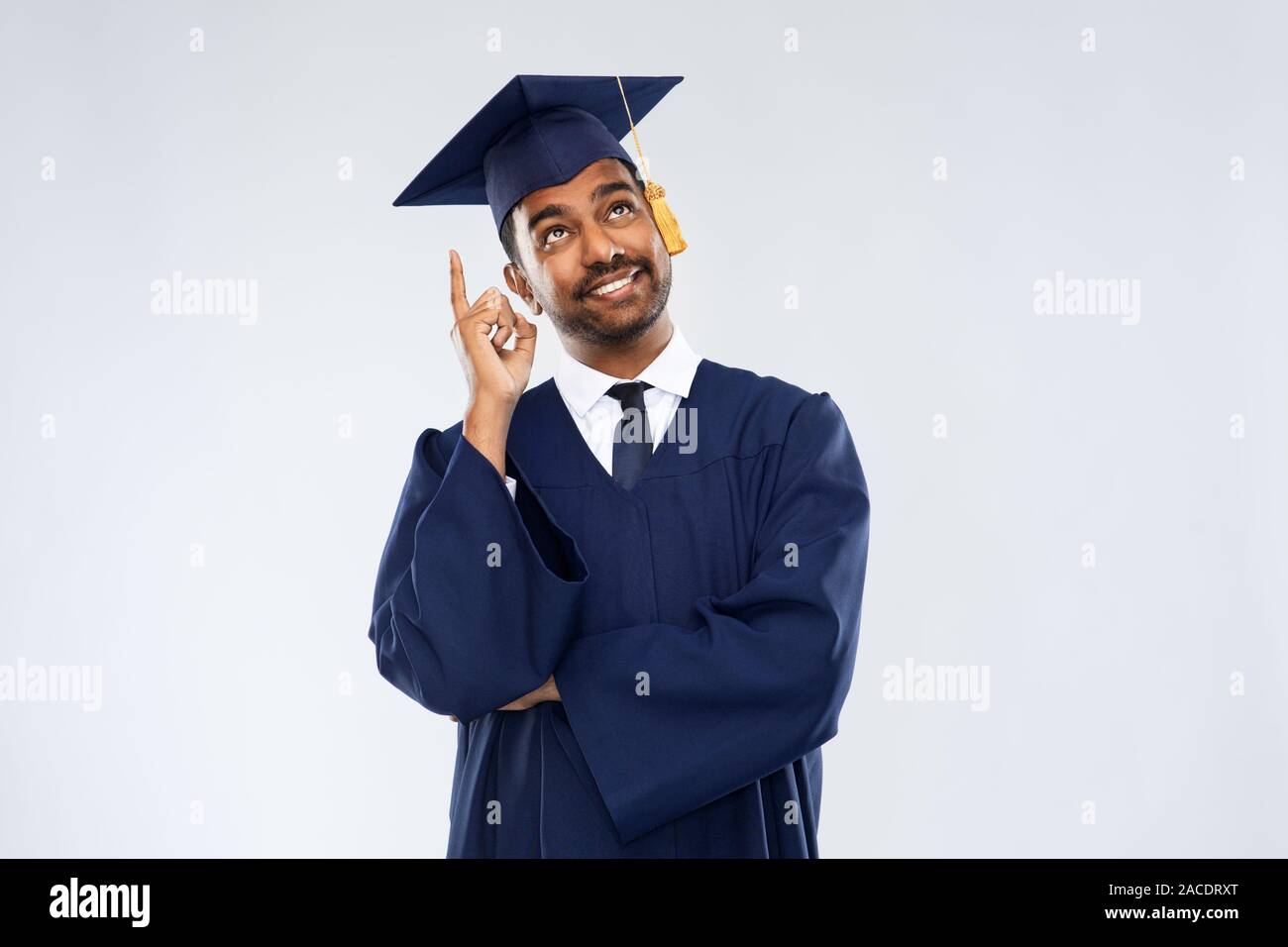 indian graduate student pointing his finger up Stock Photo - Alamy