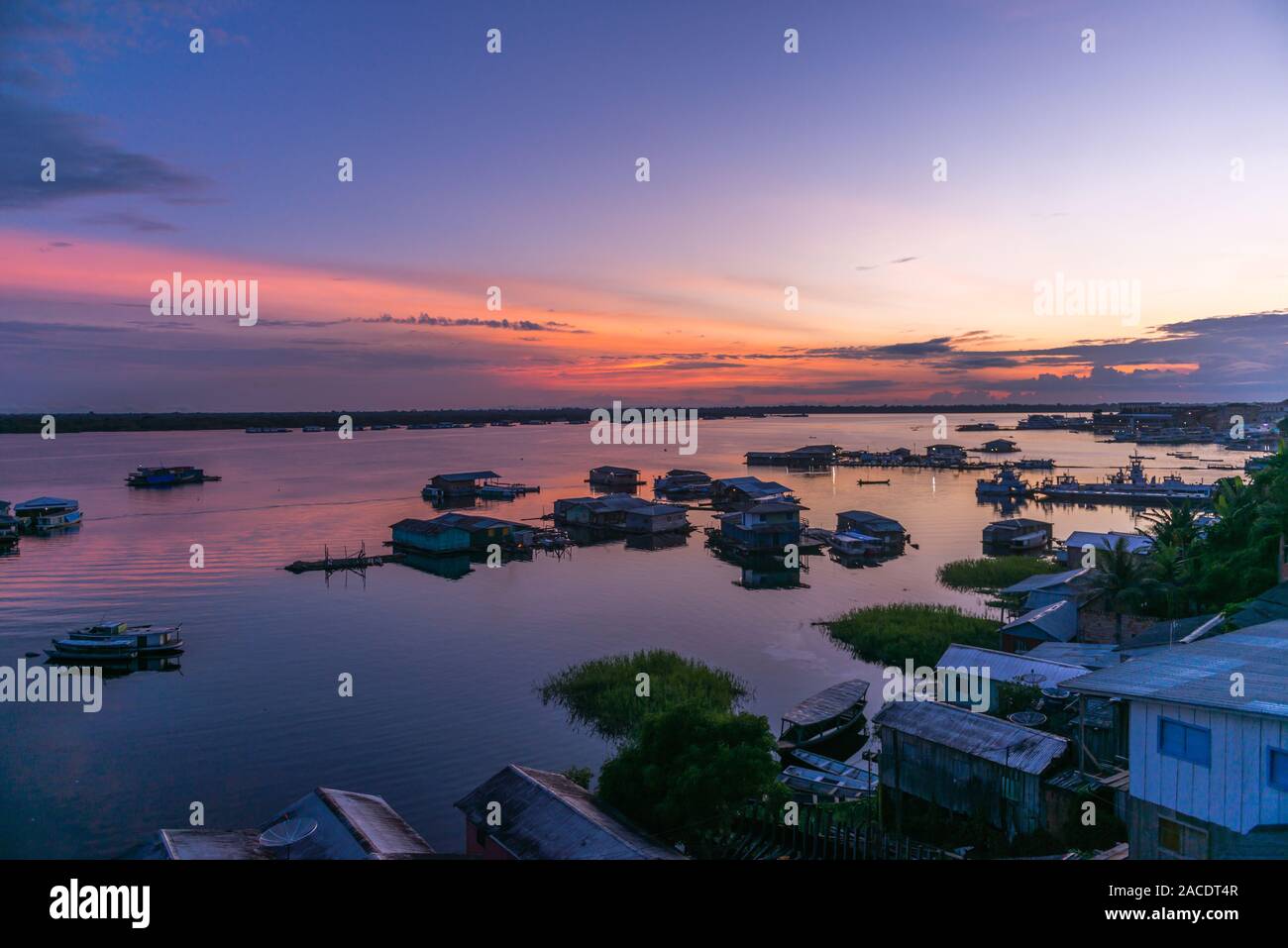 Twilight hour over the swimming houses on Lake Tefé, small town of Tefé ...