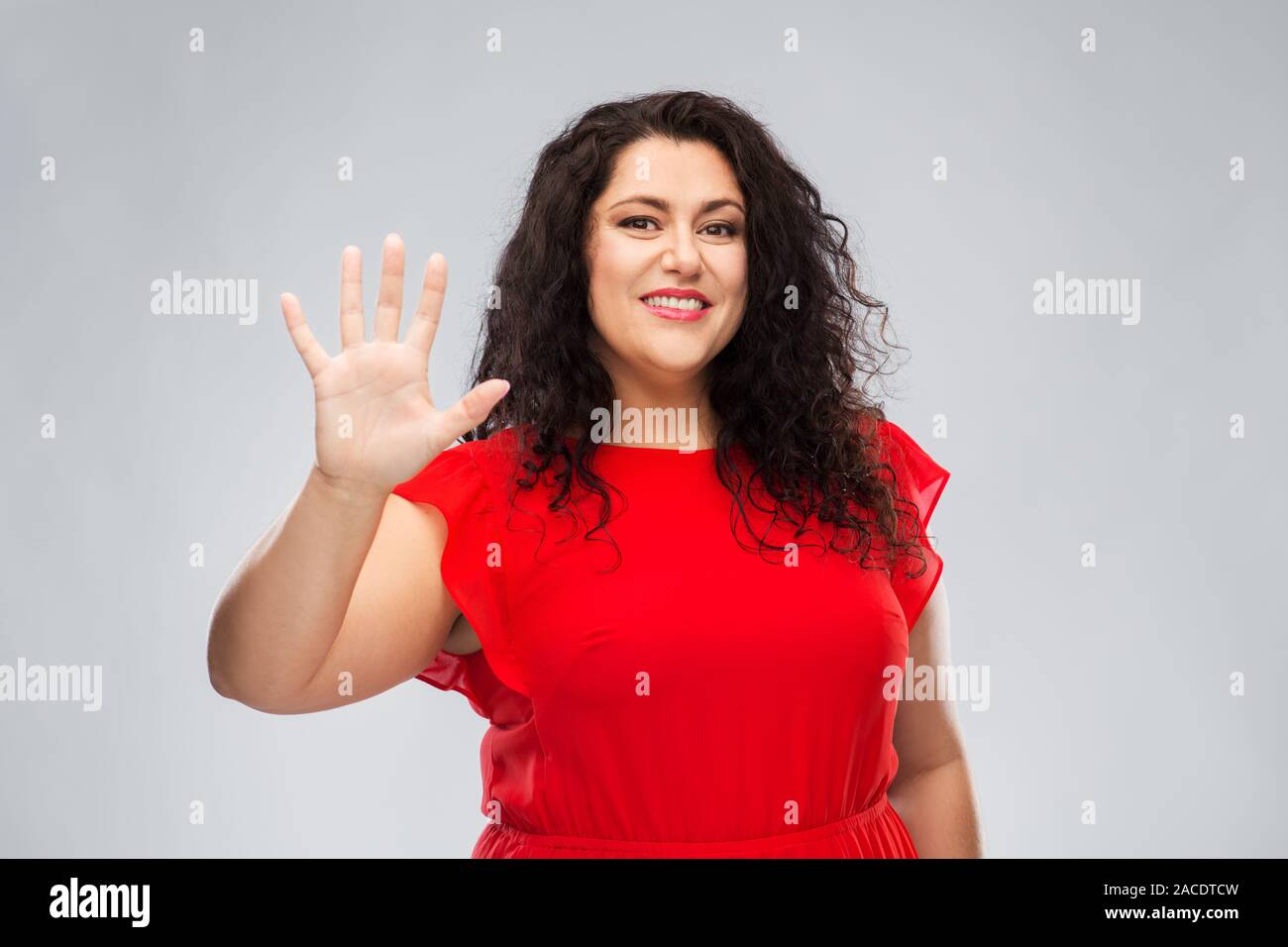 happy woman in red dress showing five fingers Stock Photo - Alamy