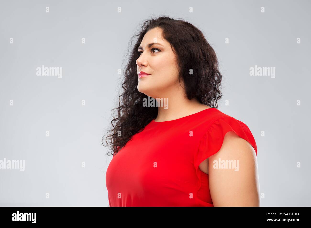 woman in red dress over grey background Stock Photo - Alamy