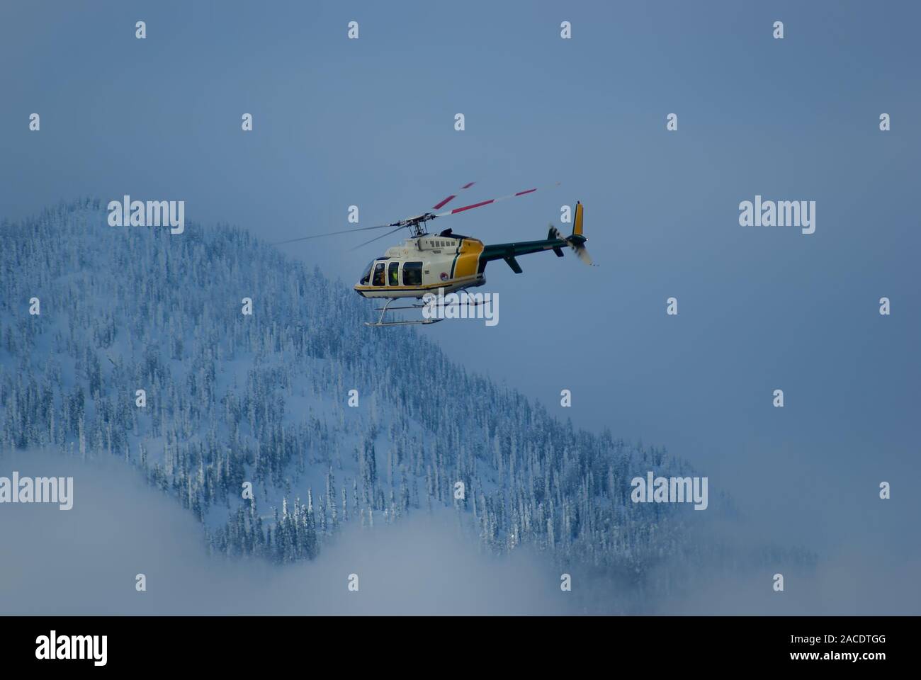 Helicopter flying through mountains hi-res stock photography and images ...