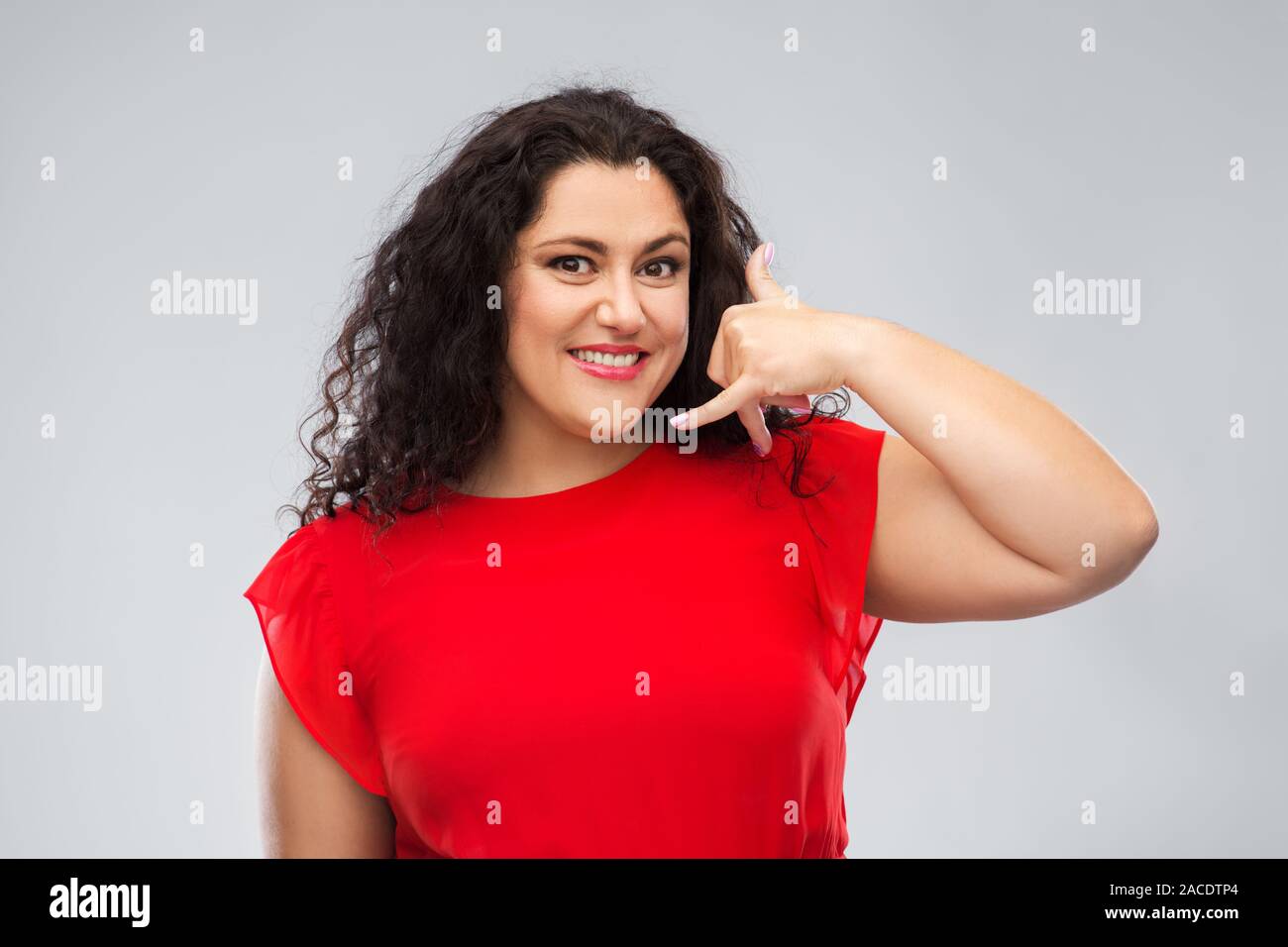 Woman in dress call gesture hi-res stock photography and images - Alamy