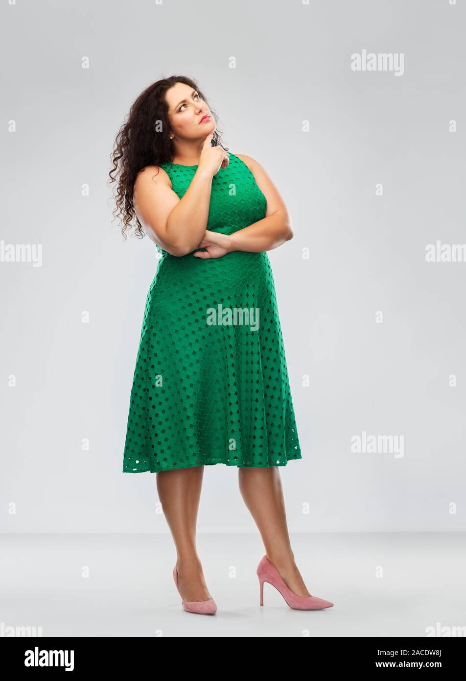 serious woman in green dress thinking Stock Photo - Alamy