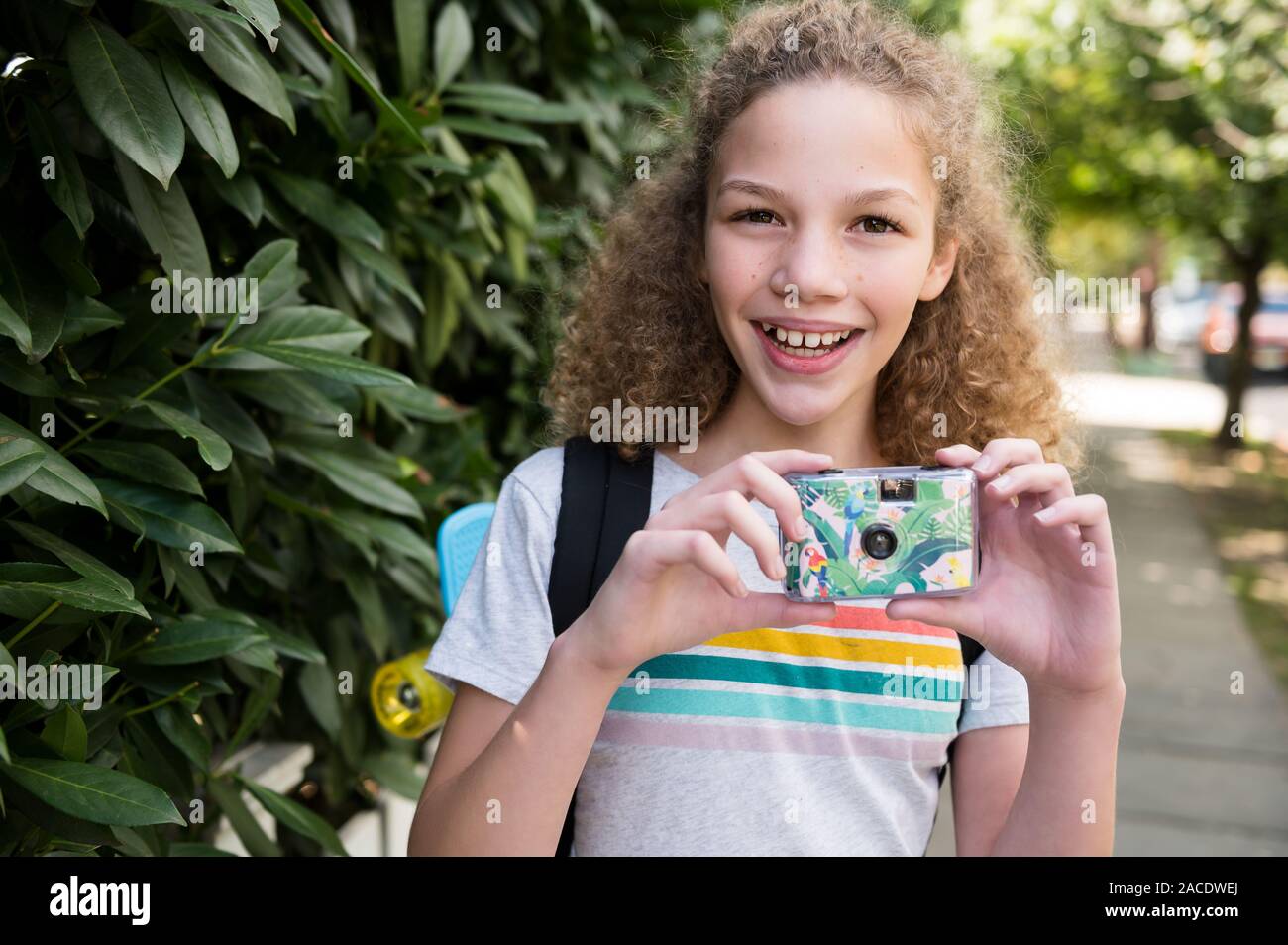 Girl holding film camera Stock Photo - Alamy