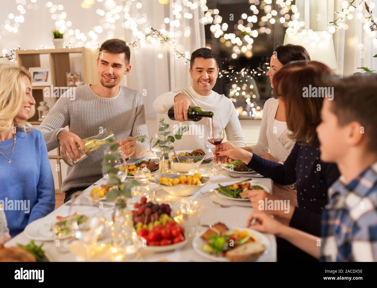 happy family having dinner party at home Stock Photo - Alamy