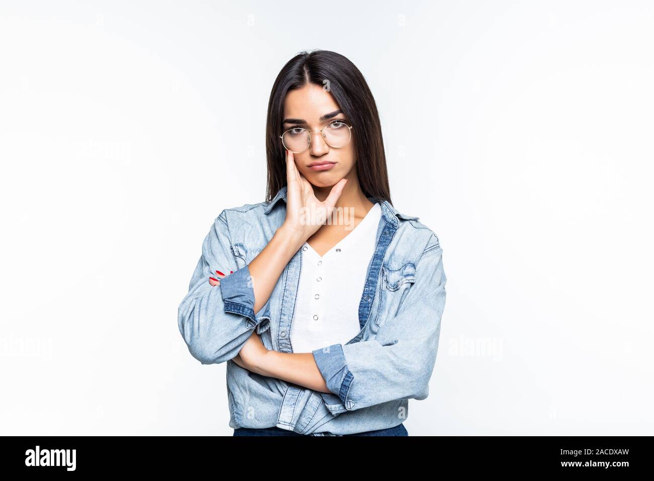 Young woman sad or offended on white background Stock Photo - Alamy