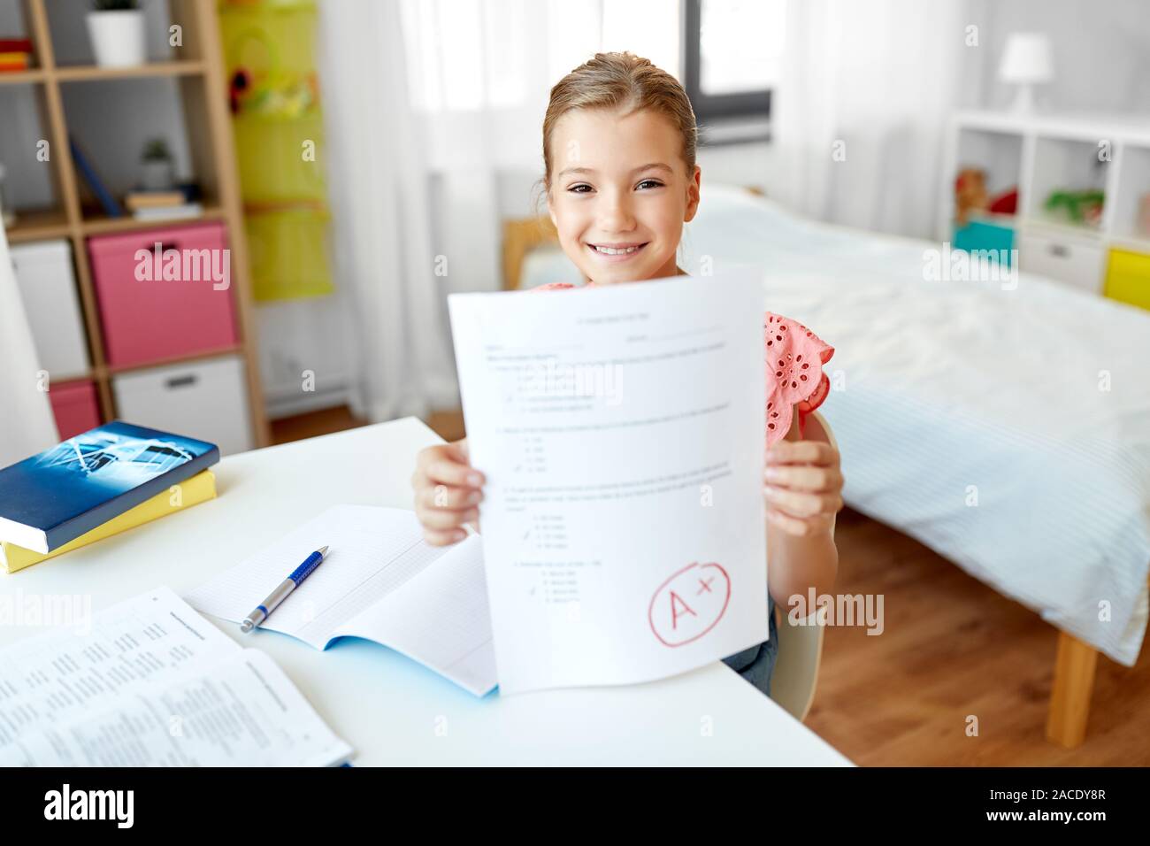 student girl with school test good mark at home Stock Photo - Alamy