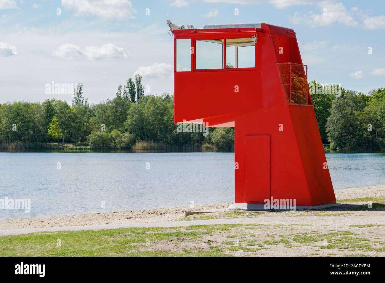 vibrant red lifeguard station or tower at swimming lake in Germany ...