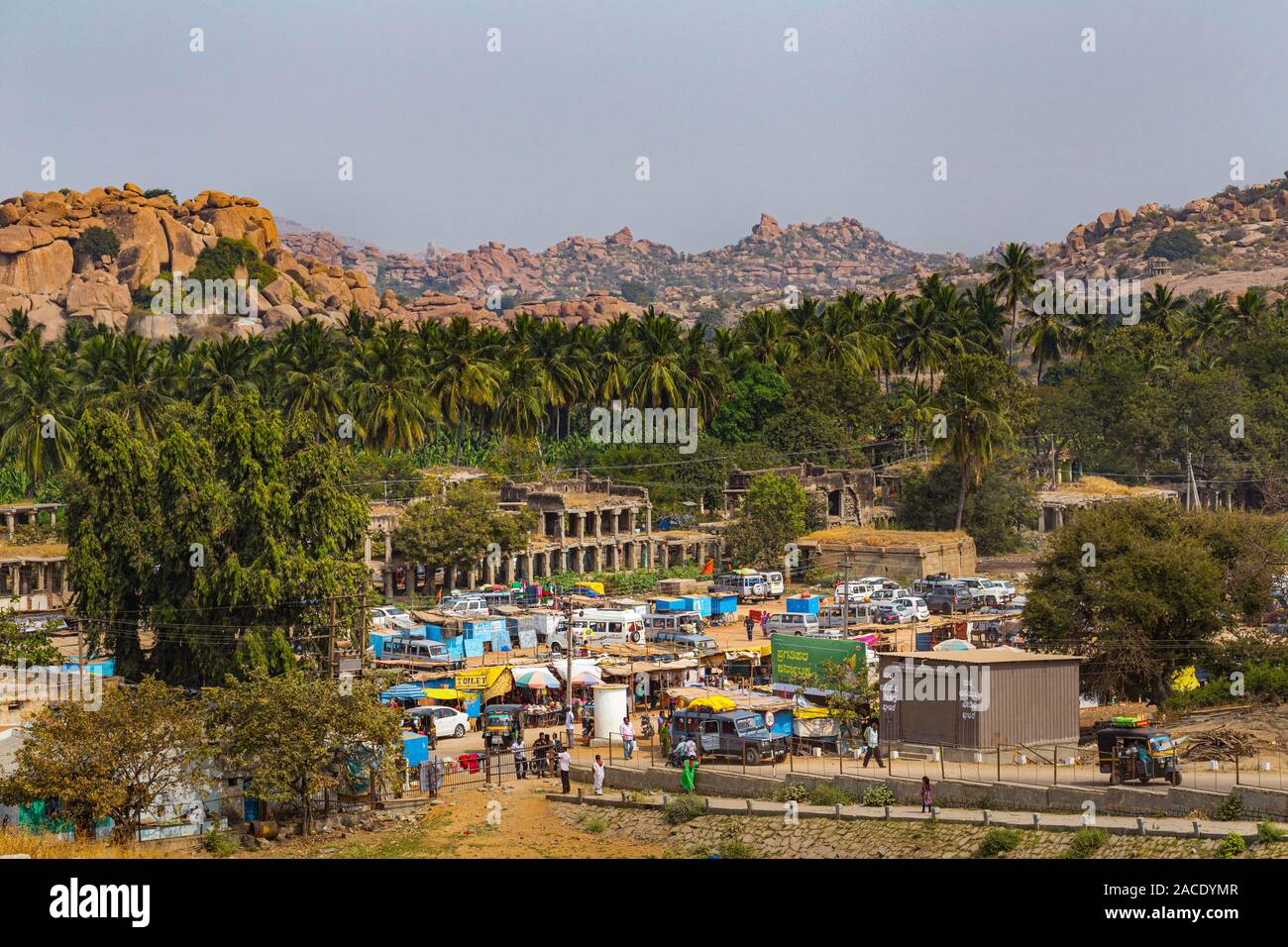 Parking near the village of Hampi. View of the Hampi Ruins. Group of ...