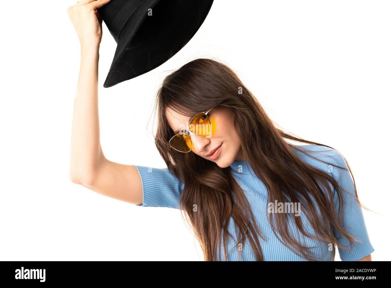 Young girl with delightful smile and black hat smiles isolated on white ...