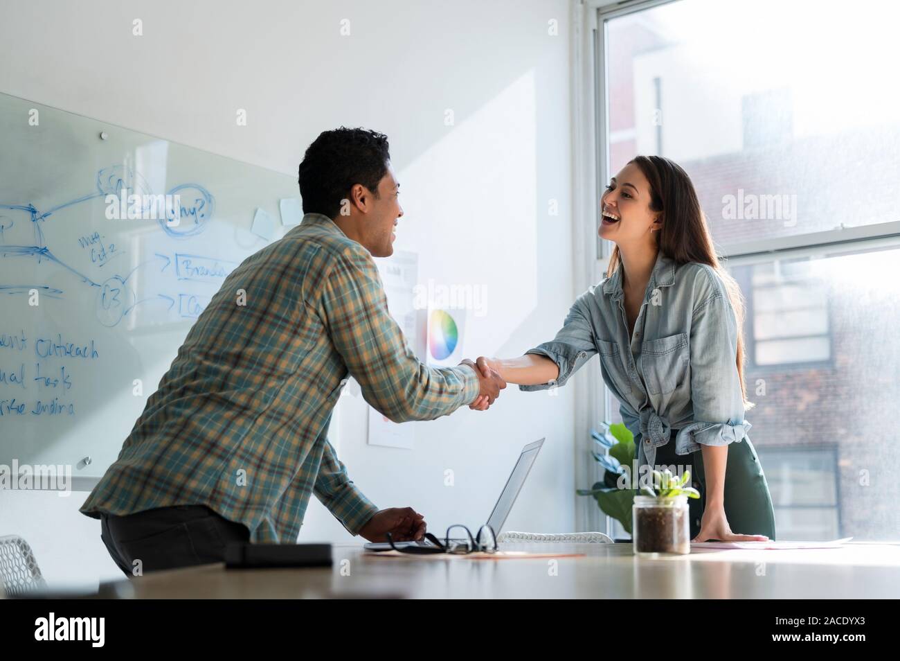 Business people shaking hands in office Stock Photo - Alamy