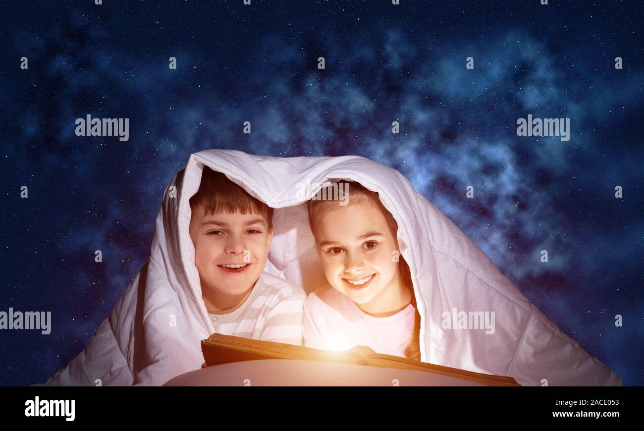 Happy children with flashlight hiding Stock Photo - Alamy