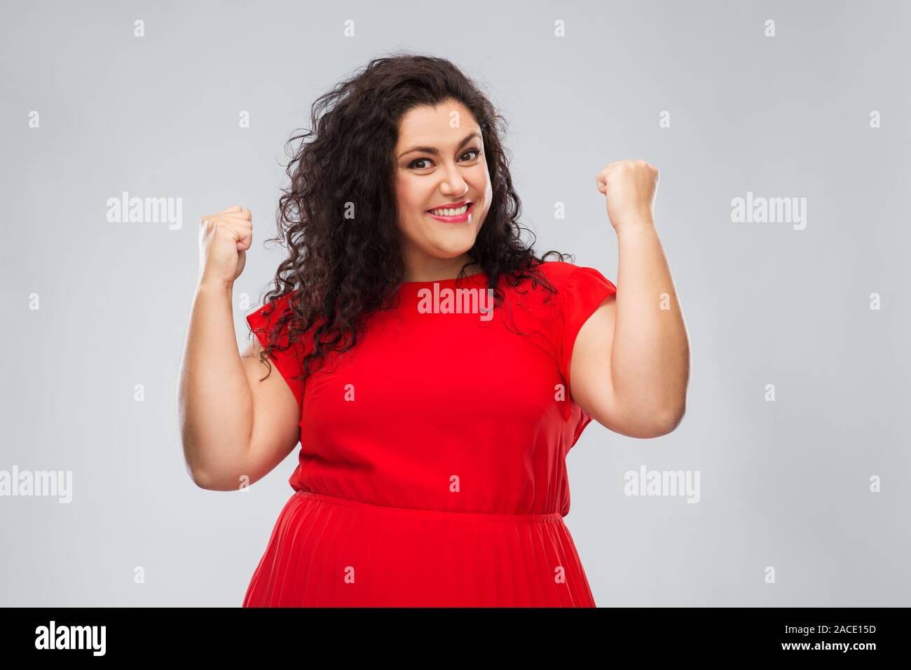 happy woman in red dress celebrating success Stock Photo - Alamy