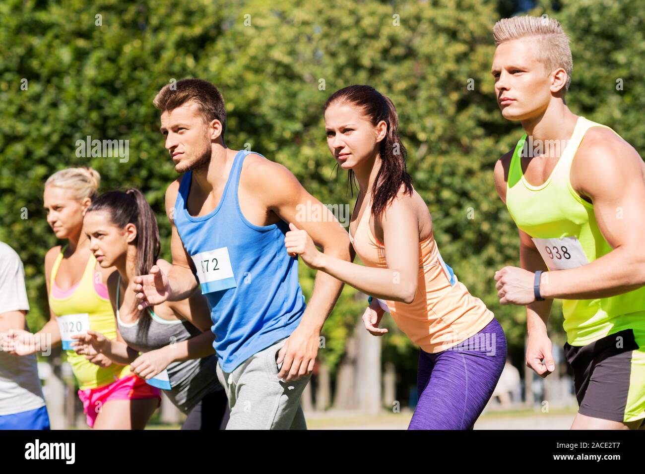 sportsmen with badge numbers on start of race Stock Photo - Alamy