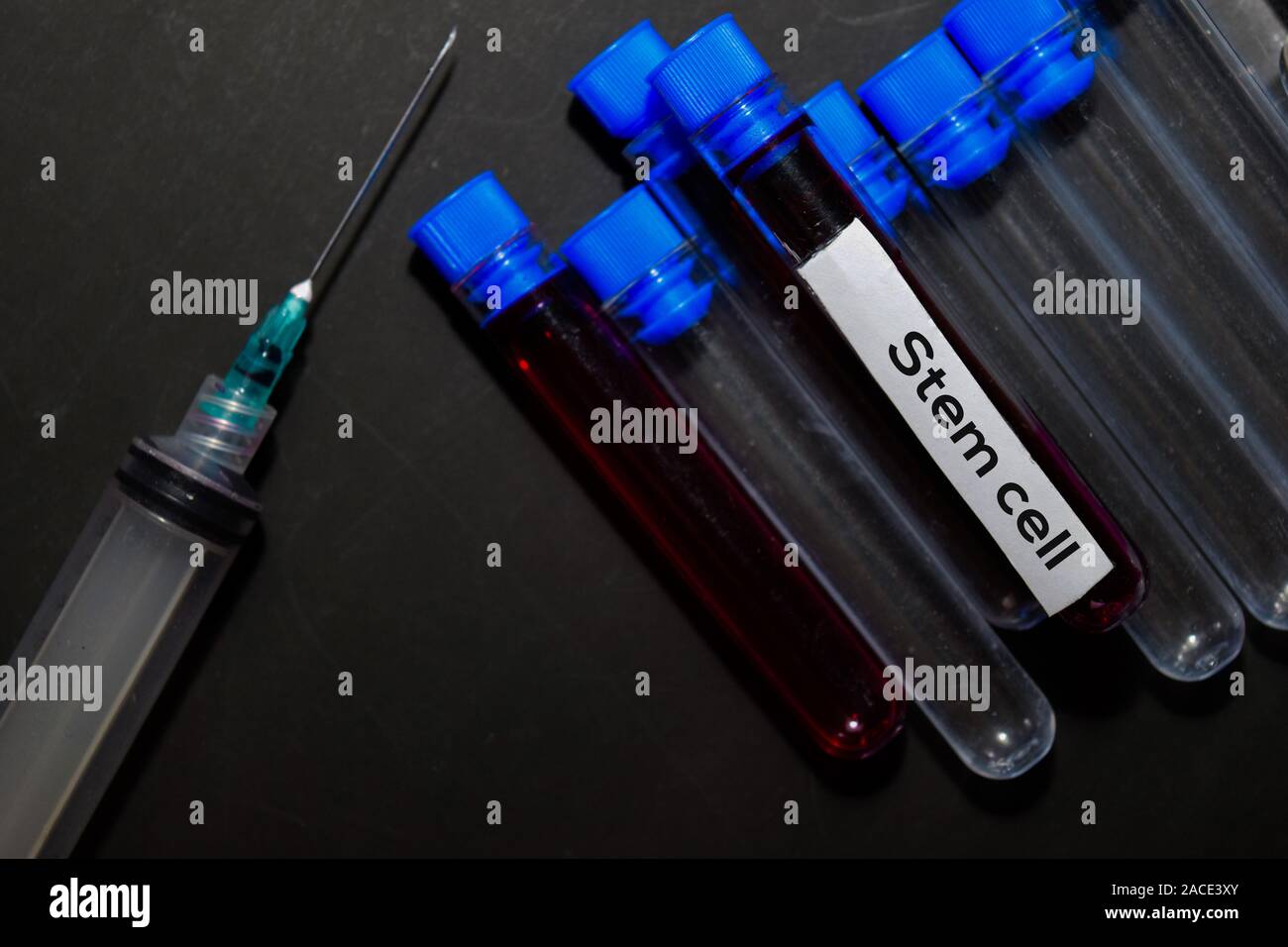 Stem Cell text with blood sample. Top view isolated on black background ...